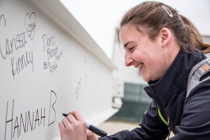 Students sign beam at Health Professions Building - Ball State Daily