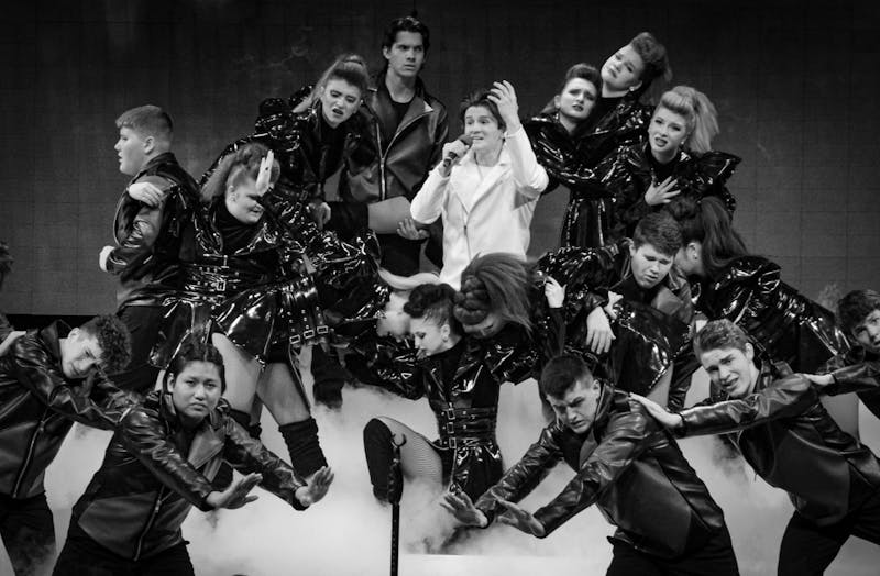 Ryan St. Pierre Sings while Members of Sound System Surround Him in a ...