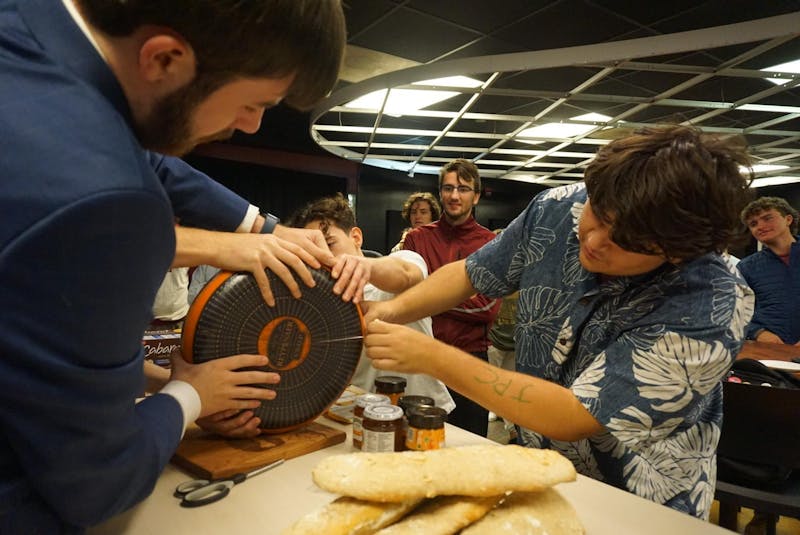 Students gather to eat 23-pound wheel of gouda cheese, provided by ...